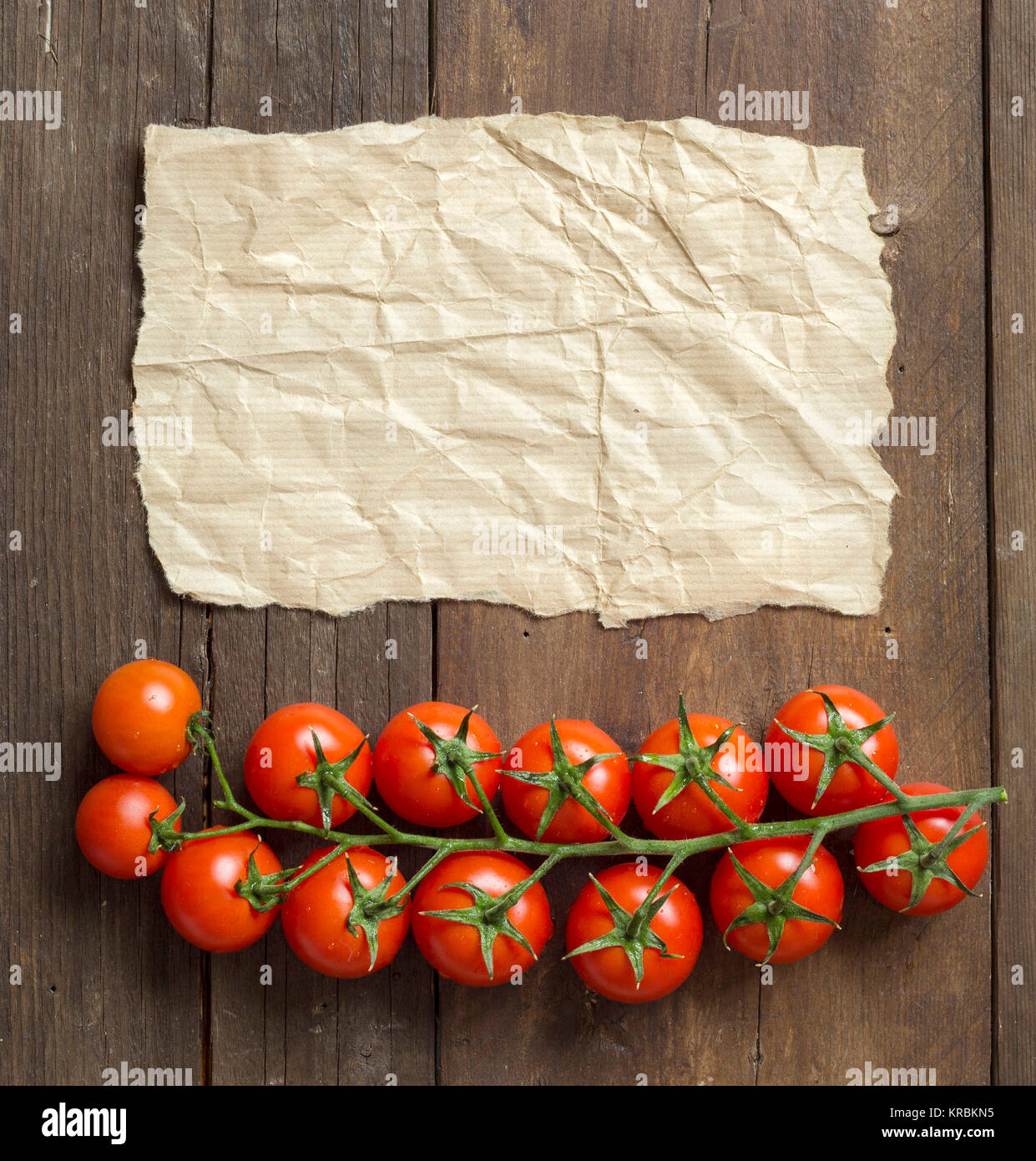 Cherry tomatoes and craft paper Stock Photo - Alamy