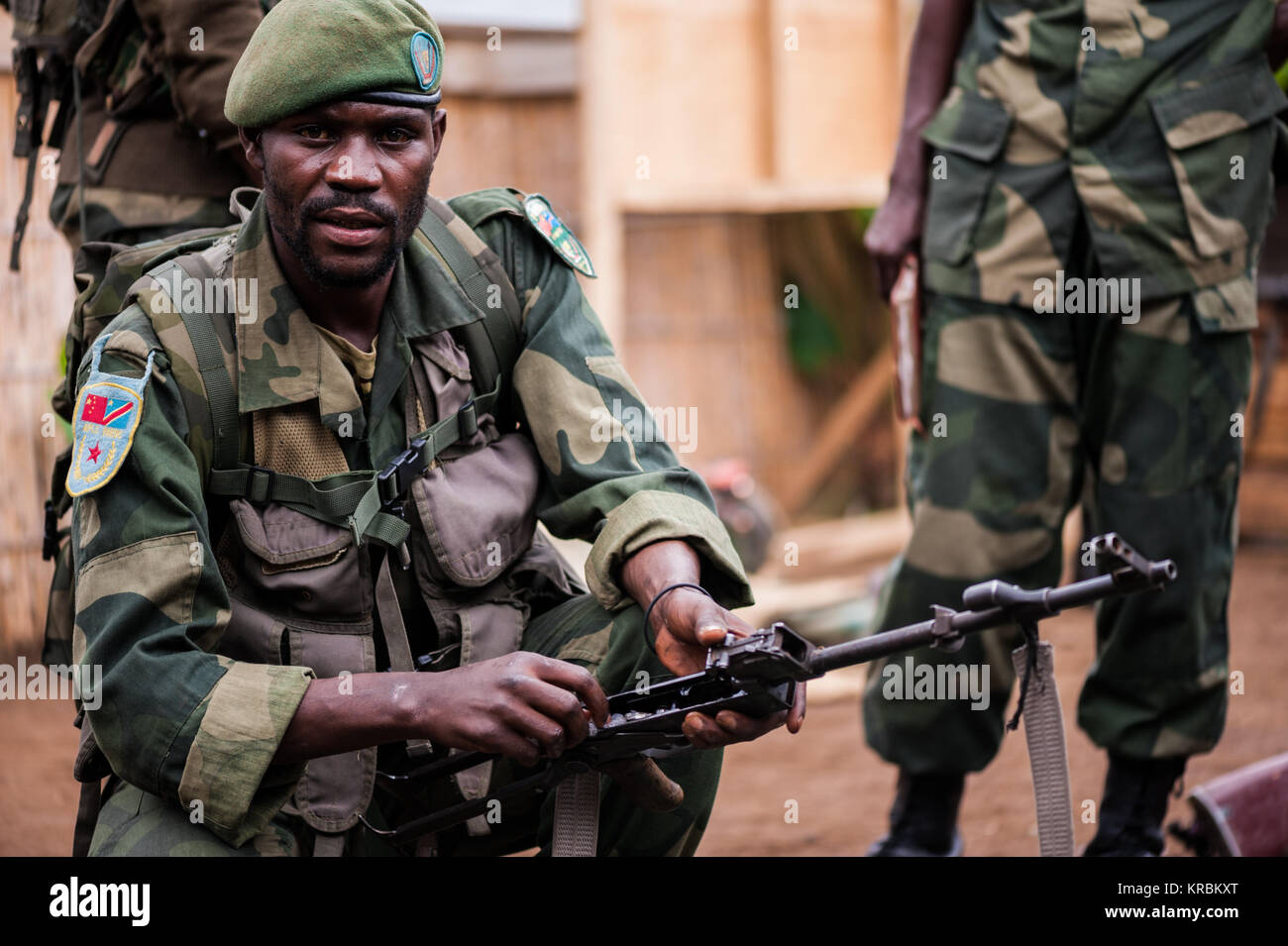 An FARDC soldier cleans and checks his weapons in the DRC's Virunga ...