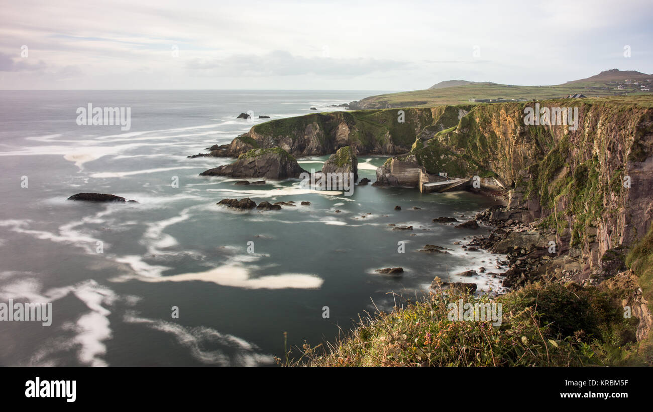 A narrow winding path leads down steep cliffs to Dunquin Pier on the ...