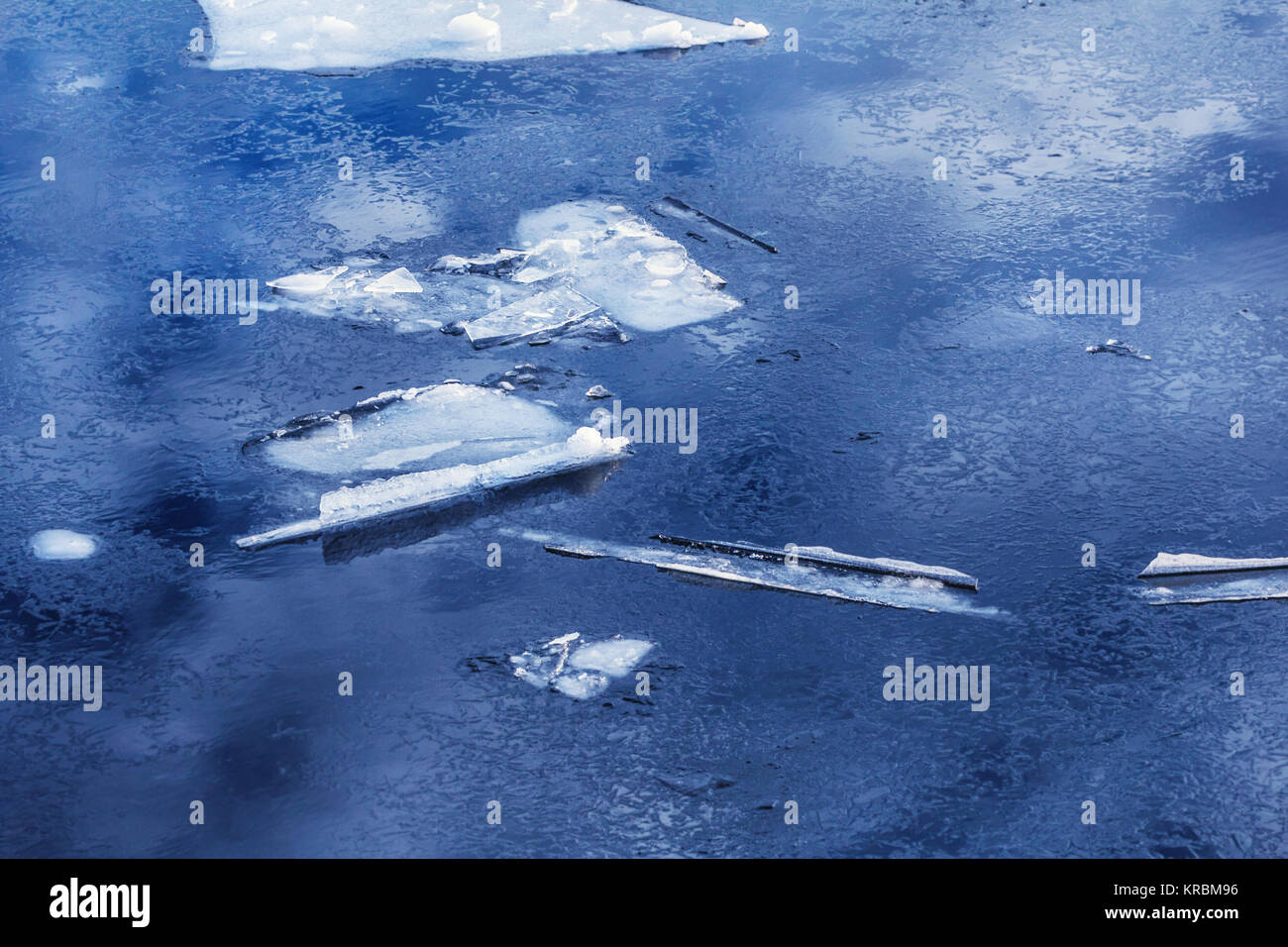 Ice in blue deep water at winter cloudy weather Stock Photo - Alamy