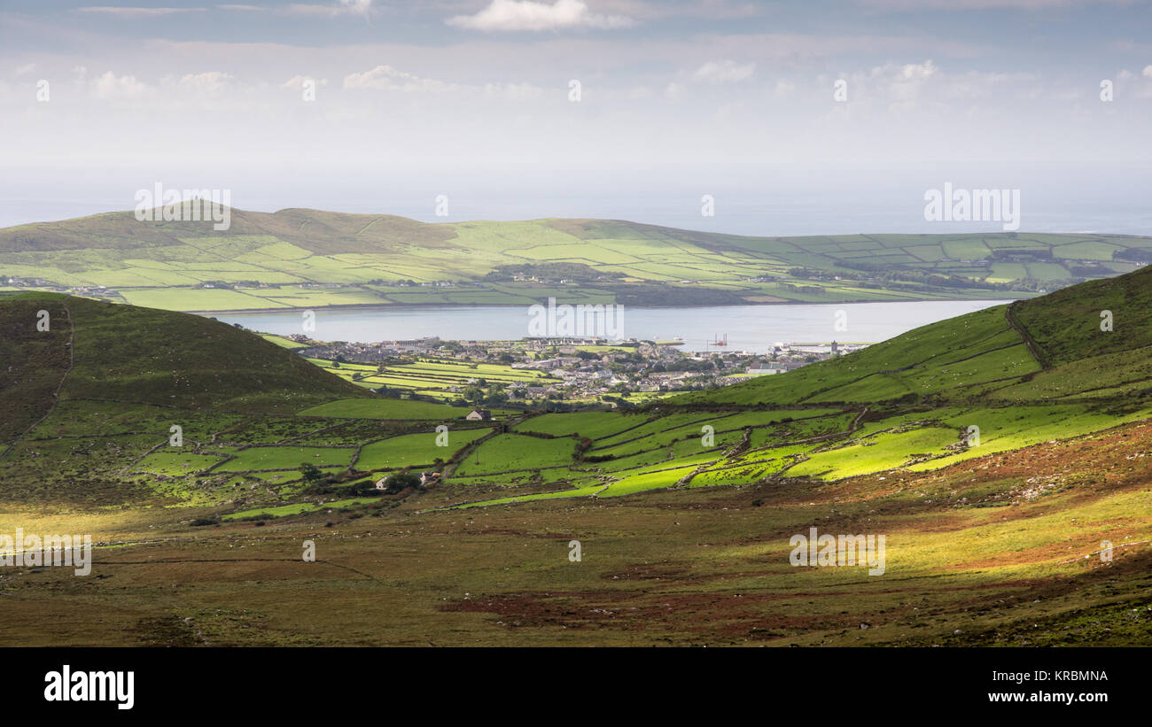 Dingle town and harbour nestled amongst the hills and mountains of the ...