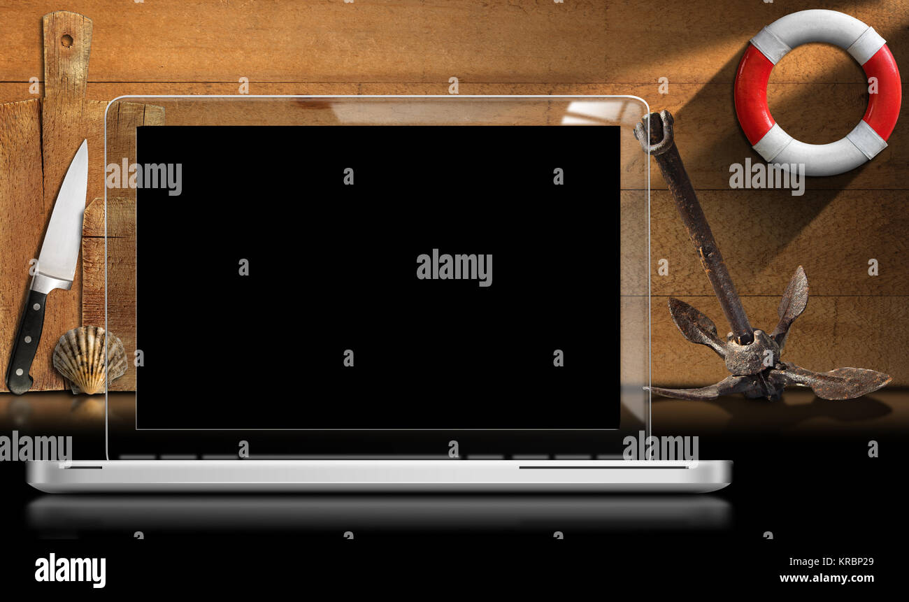 Laptop computer in a kitchen with cutting boards, knife, rusty anchor ...