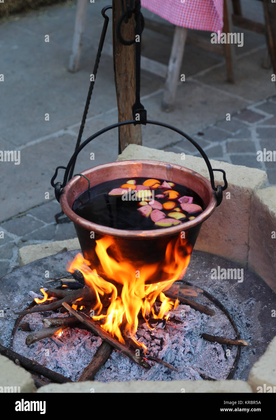 big cauldron above the fire with the hot mulled WINE during the ...