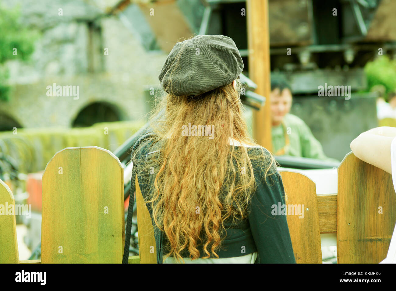 young woman looking over a fence Stock Photo - Alamy