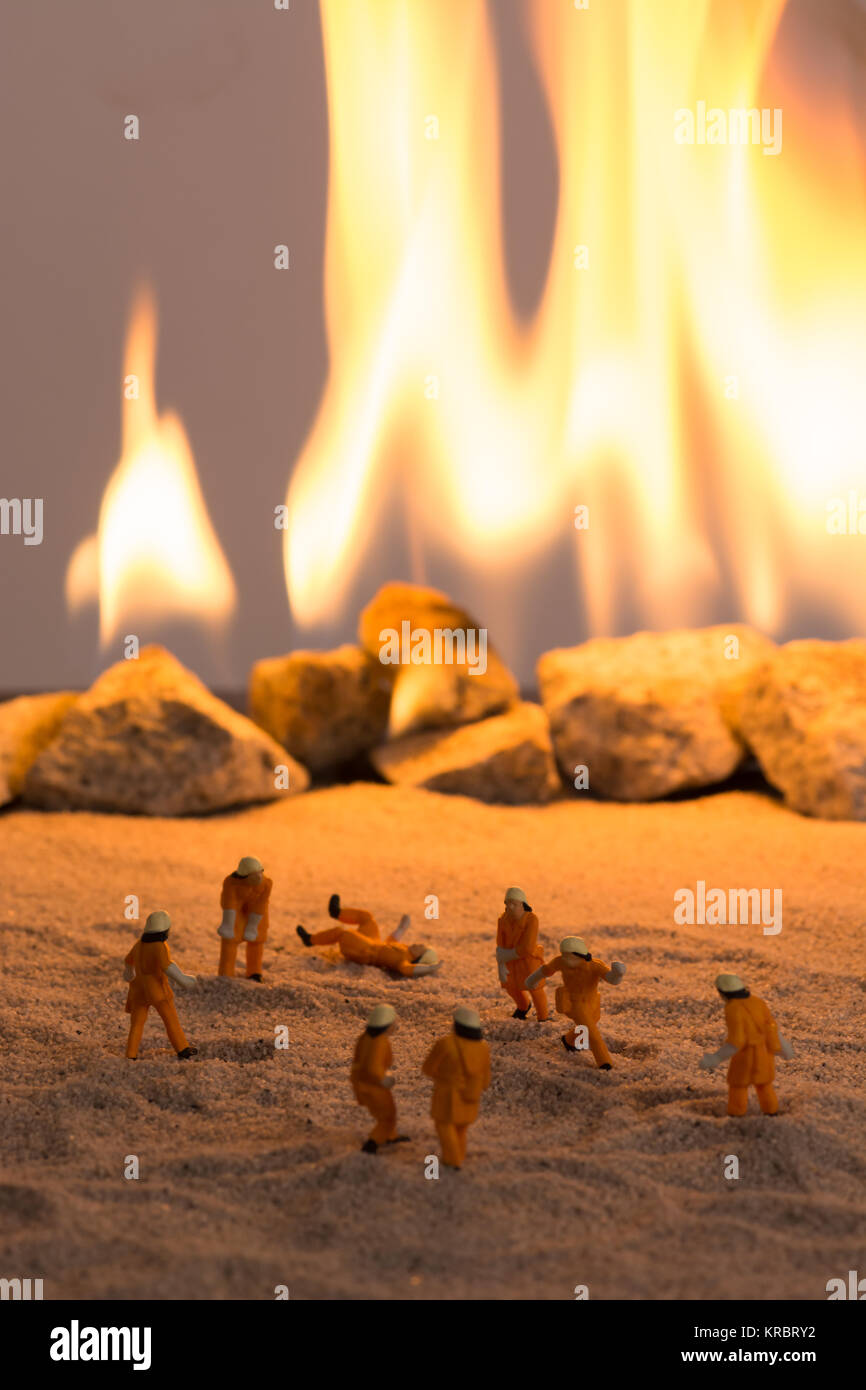 Miniature firemen at work near real fire Stock Photo - Alamy