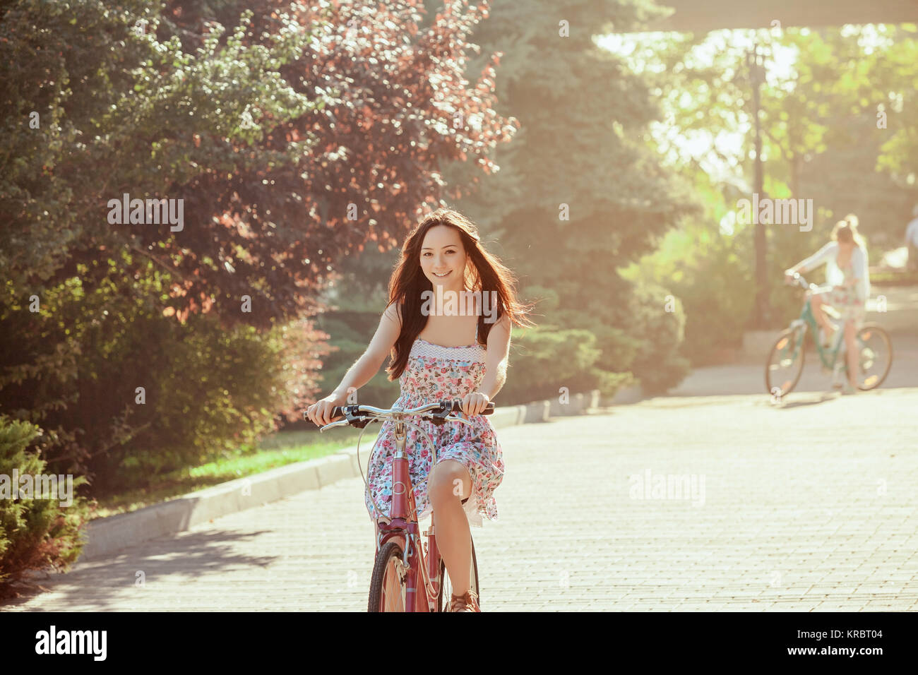 The young girl with bicycle in park Stock Photo - Alamy