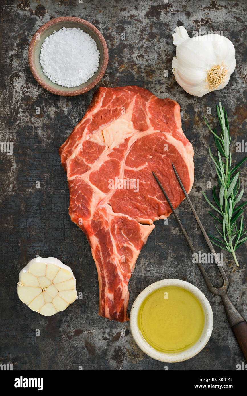 Dry aged rib eye steak on dark rustic background Stock Photo - Alamy