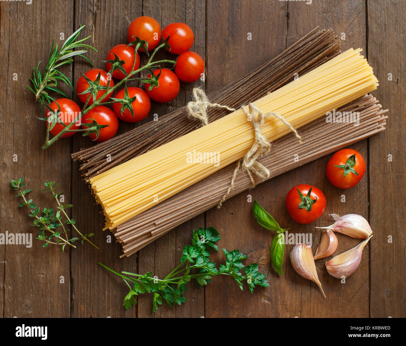 Three types of spaghetti, tomatoes and herbs Stock Photo - Alamy