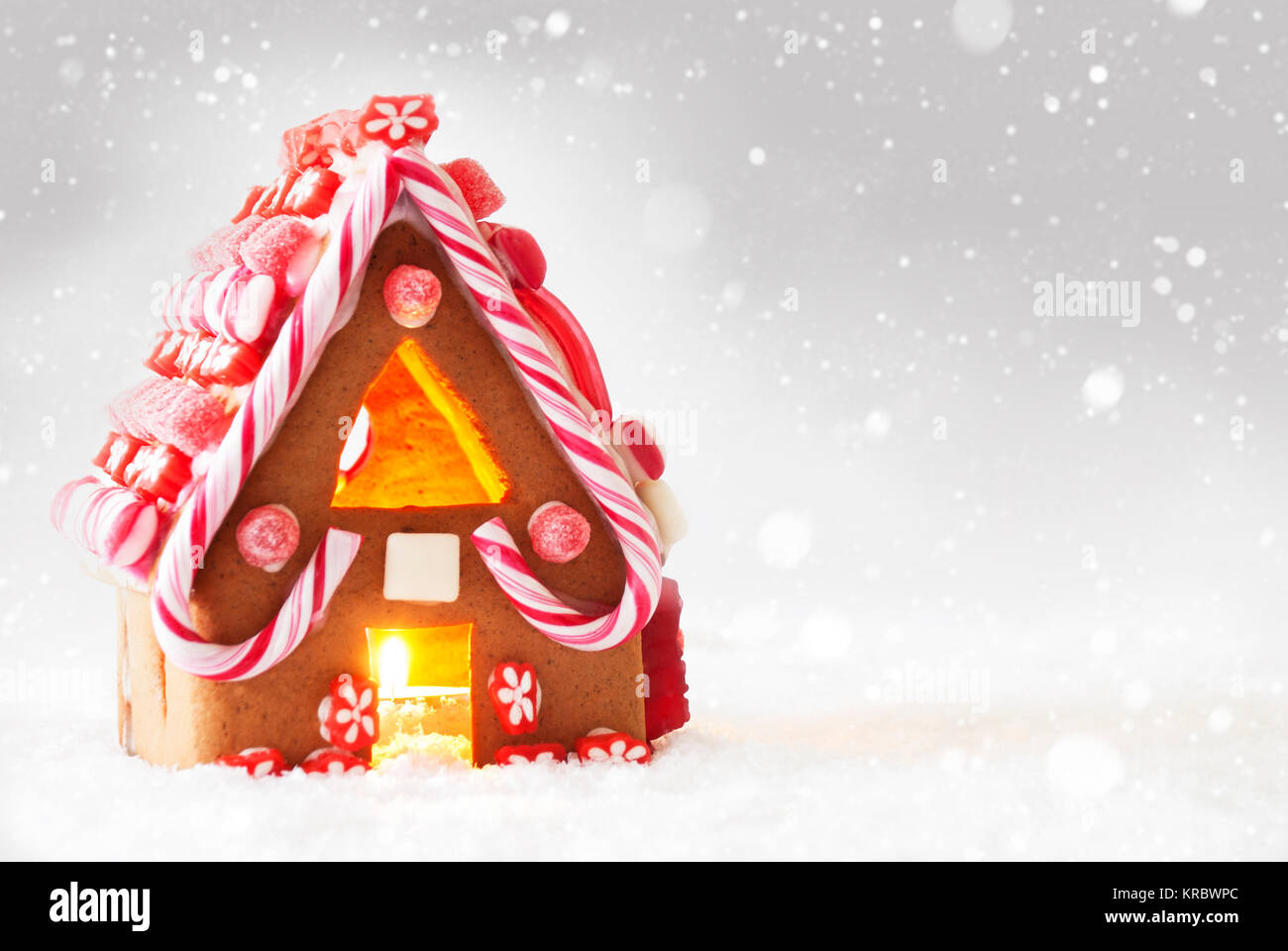 Gingerbread House In Snow As Christmas Decoration. Candlelight For ...