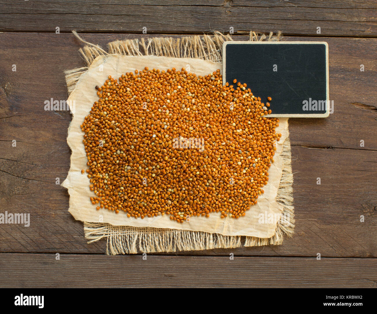 Whole brown millet pile with a small chalkboard Stock Photo - Alamy