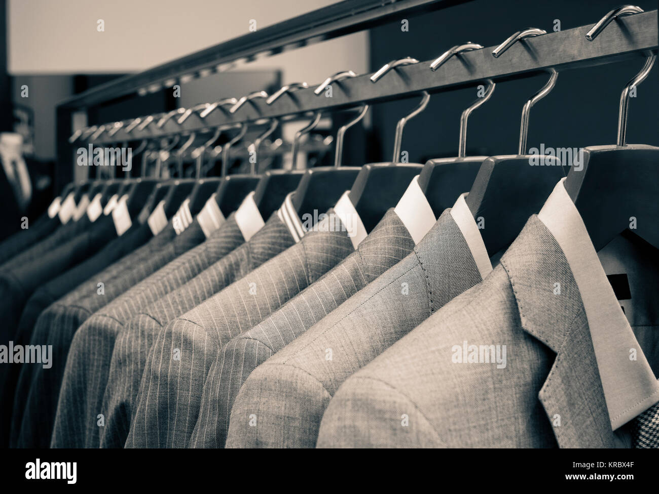 Men suits hanging in a clothing store Stock Photo - Alamy