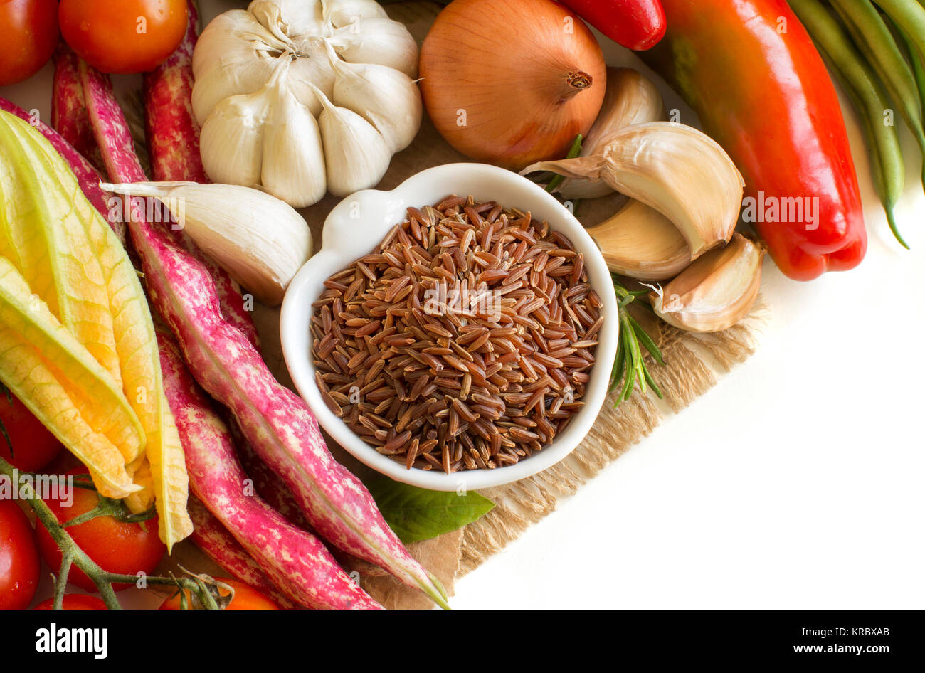 Red rice in bowl and fresh vegetables Stock Photo - Alamy