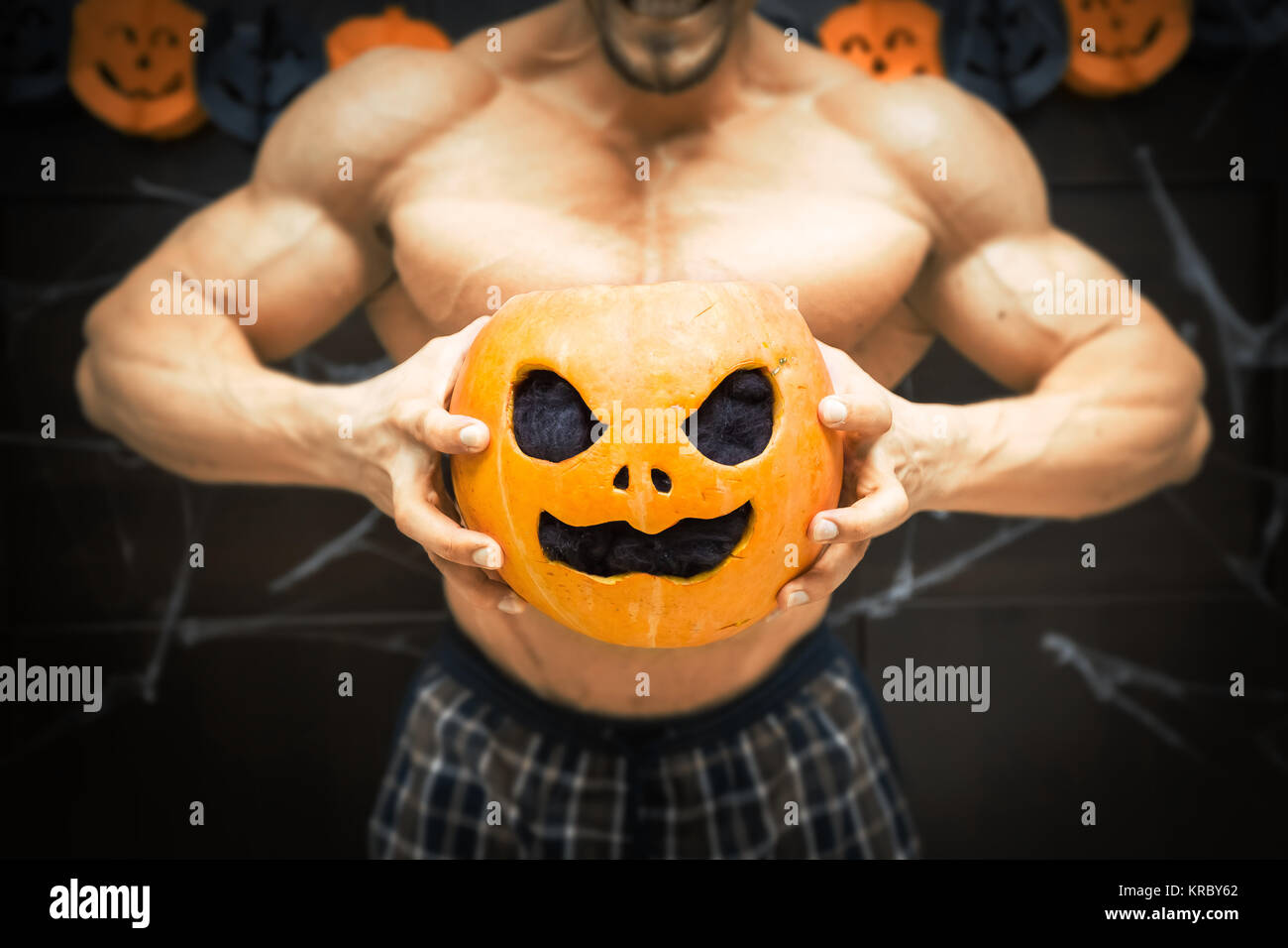 Halloween bodybuilder with pumpkin Stock Photo - Alamy
