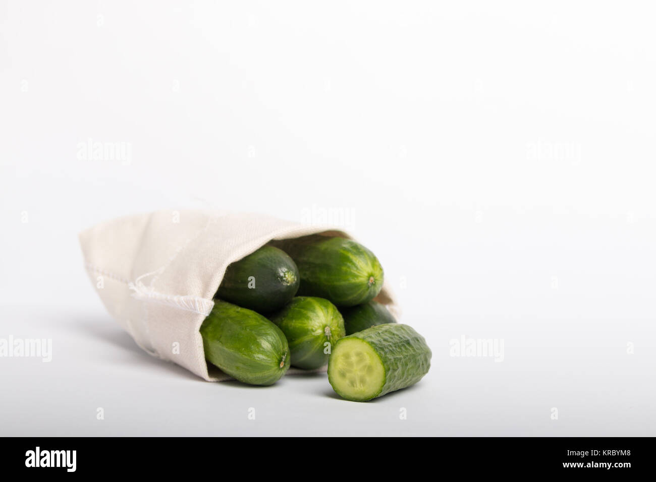 mini cucumber in a bag isolated on a white background Stock Photo - Alamy