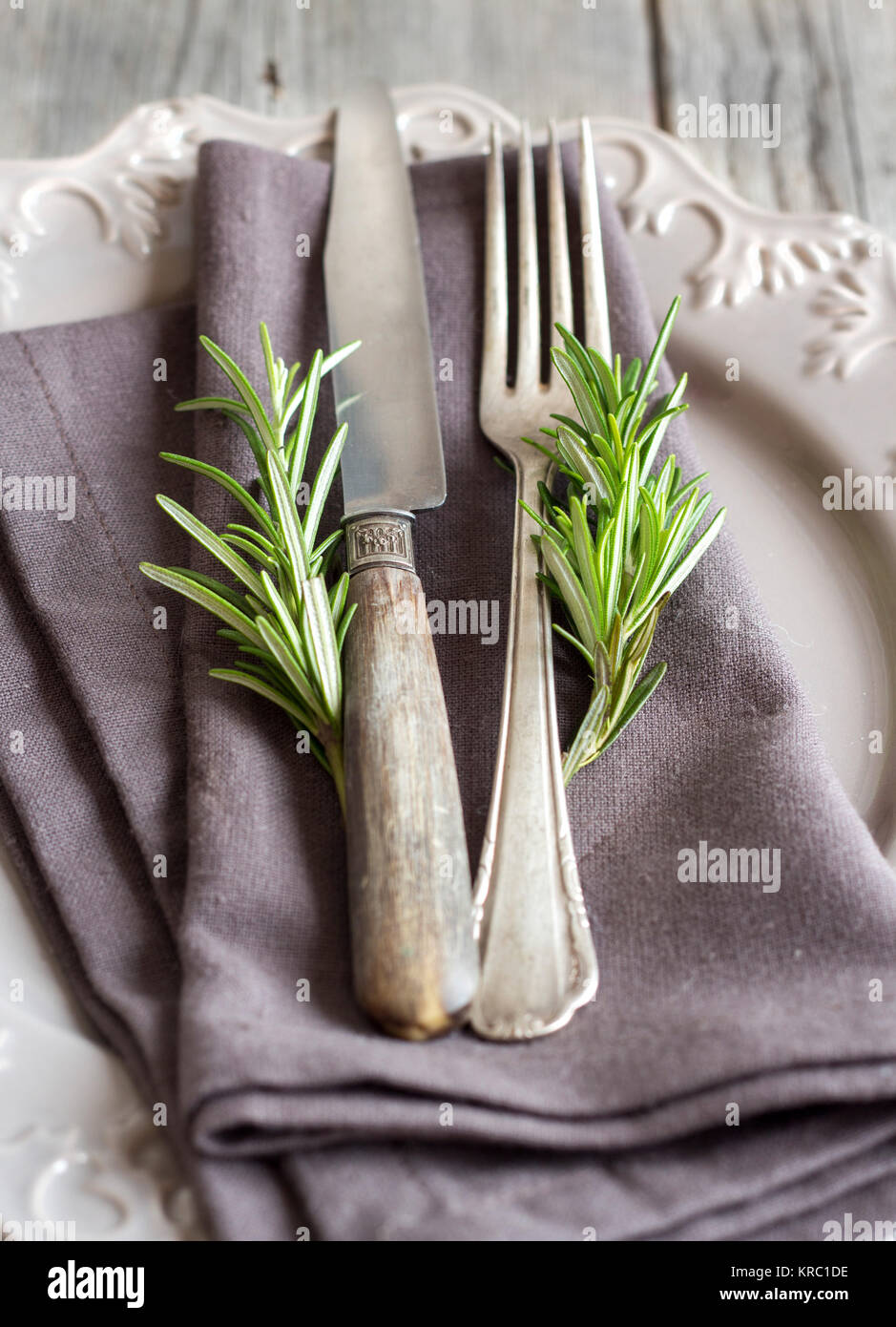 Vintage Table setting with rosemary decor Stock Photo - Alamy