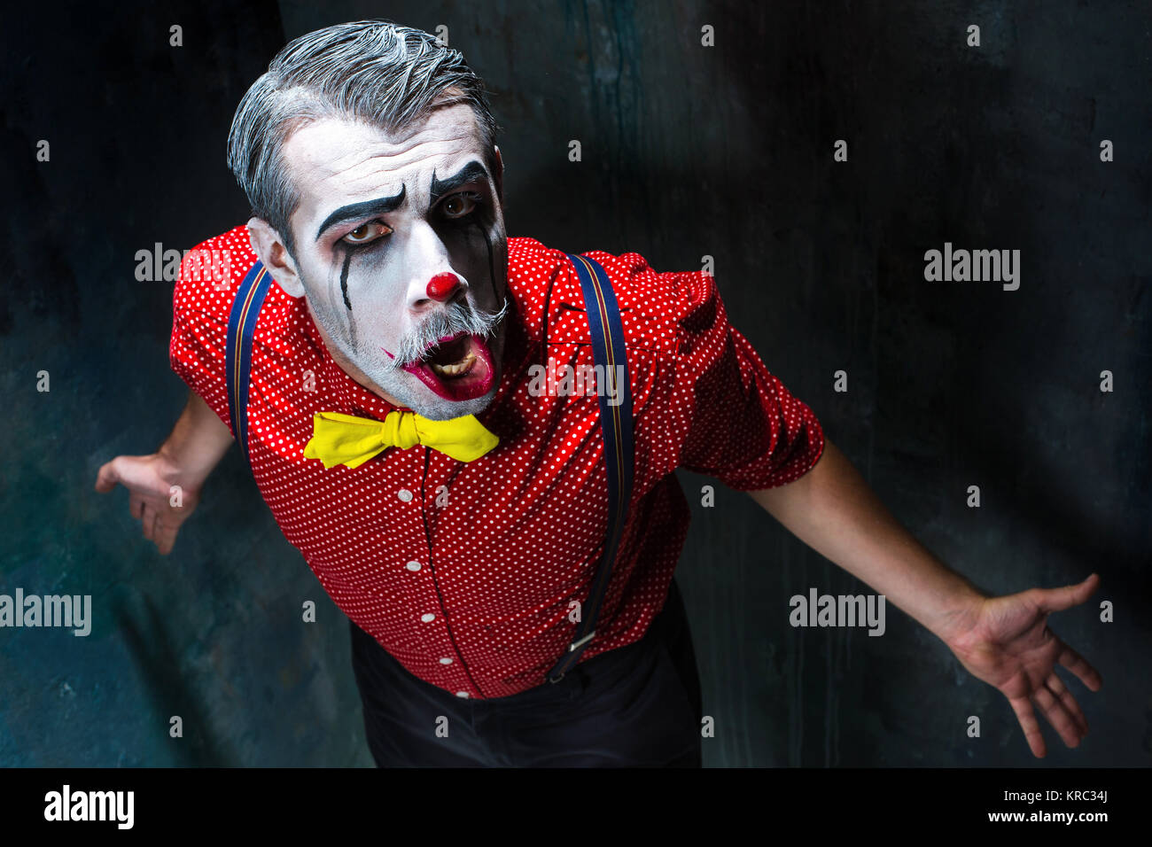 Terrible clown and Halloween theme: Crazy red clown in a shirt with ...