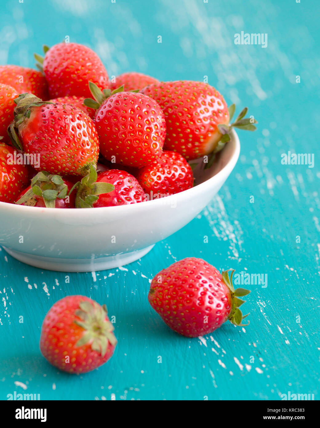 Strawberries on turquoise wooden table Stock Photo - Alamy