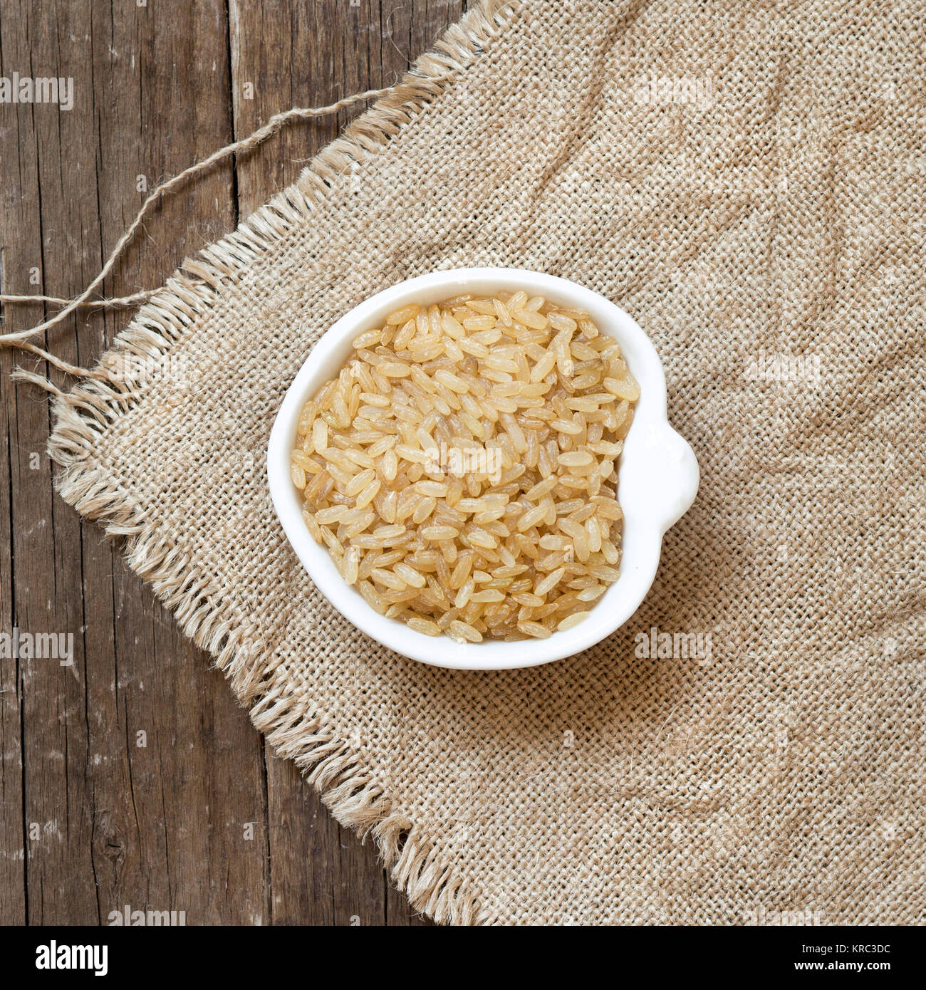 Raw unpolished rice in a bowl Stock Photo - Alamy