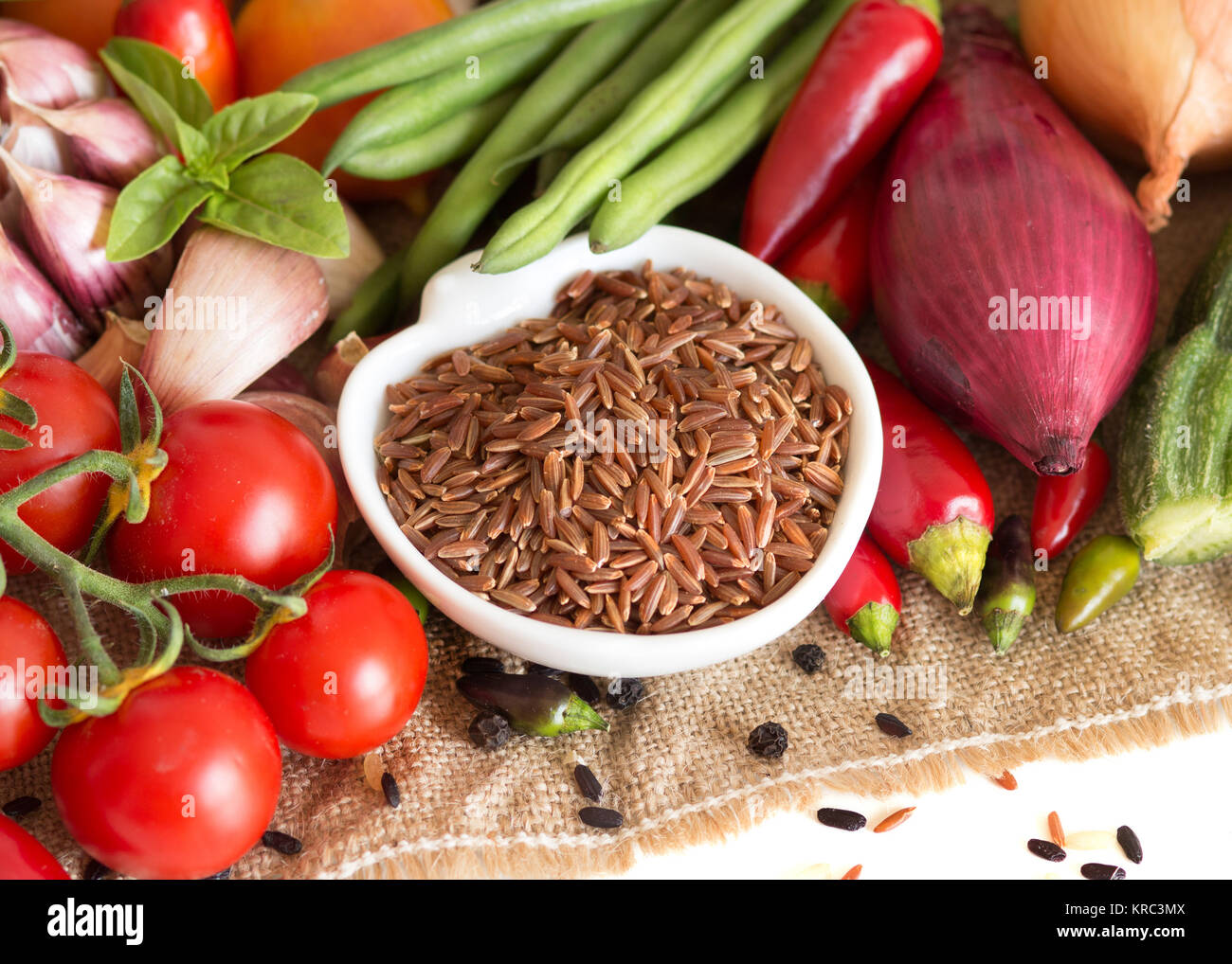 Red organic rice in bowl and vegetables Stock Photo - Alamy