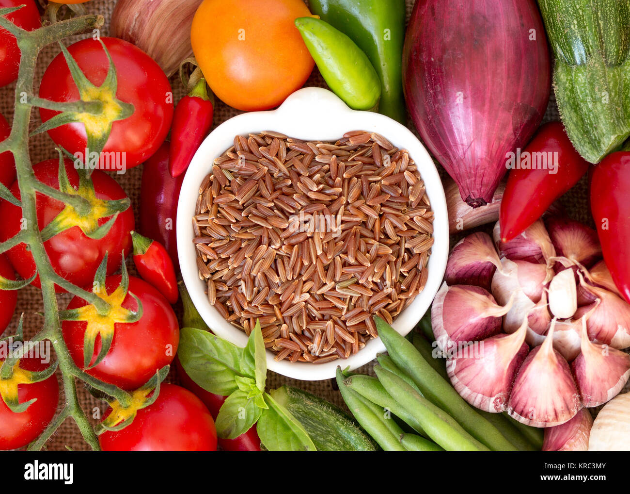 Red organic rice in bowl and vegetables Stock Photo - Alamy
