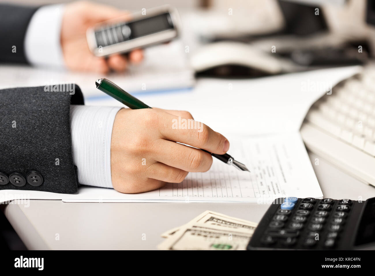 Working business man hand pen writing paper document at office ...