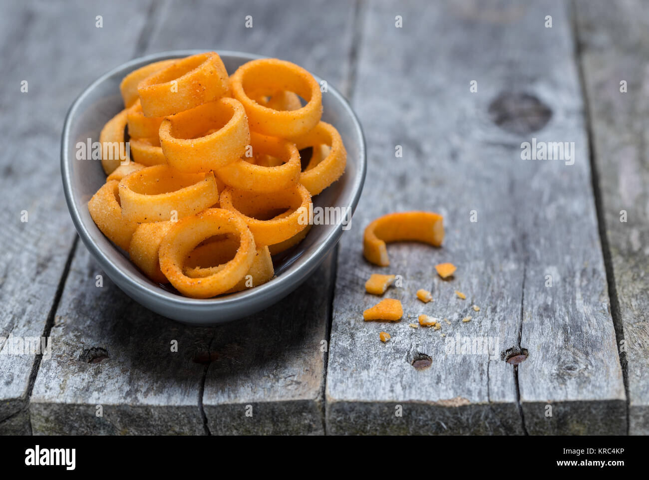 Potato rings on gray rustic wood Stock Photo - Alamy