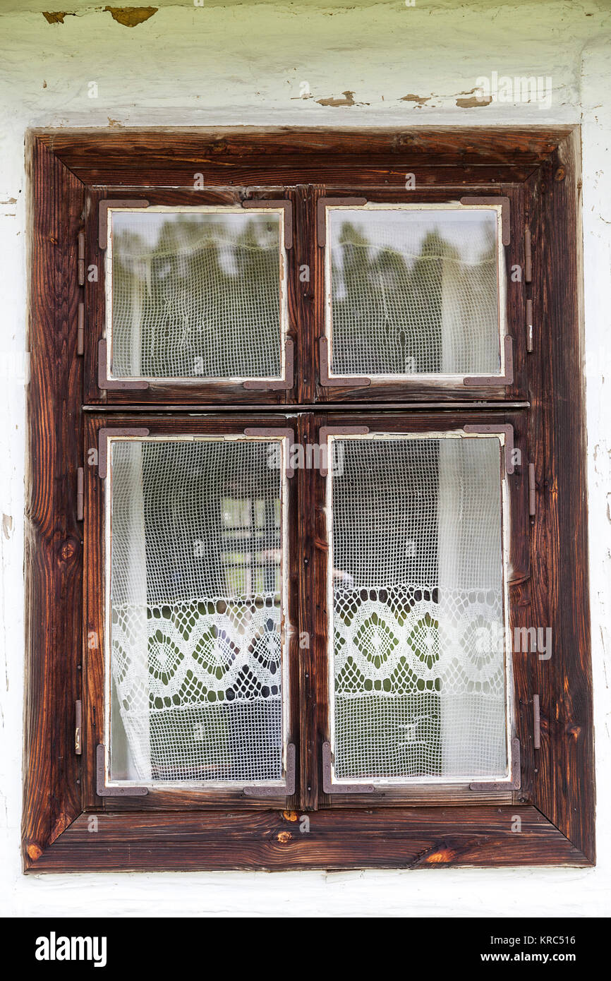 window with lace curtain of old cottage in open-air museum, Kolbuszowa ...