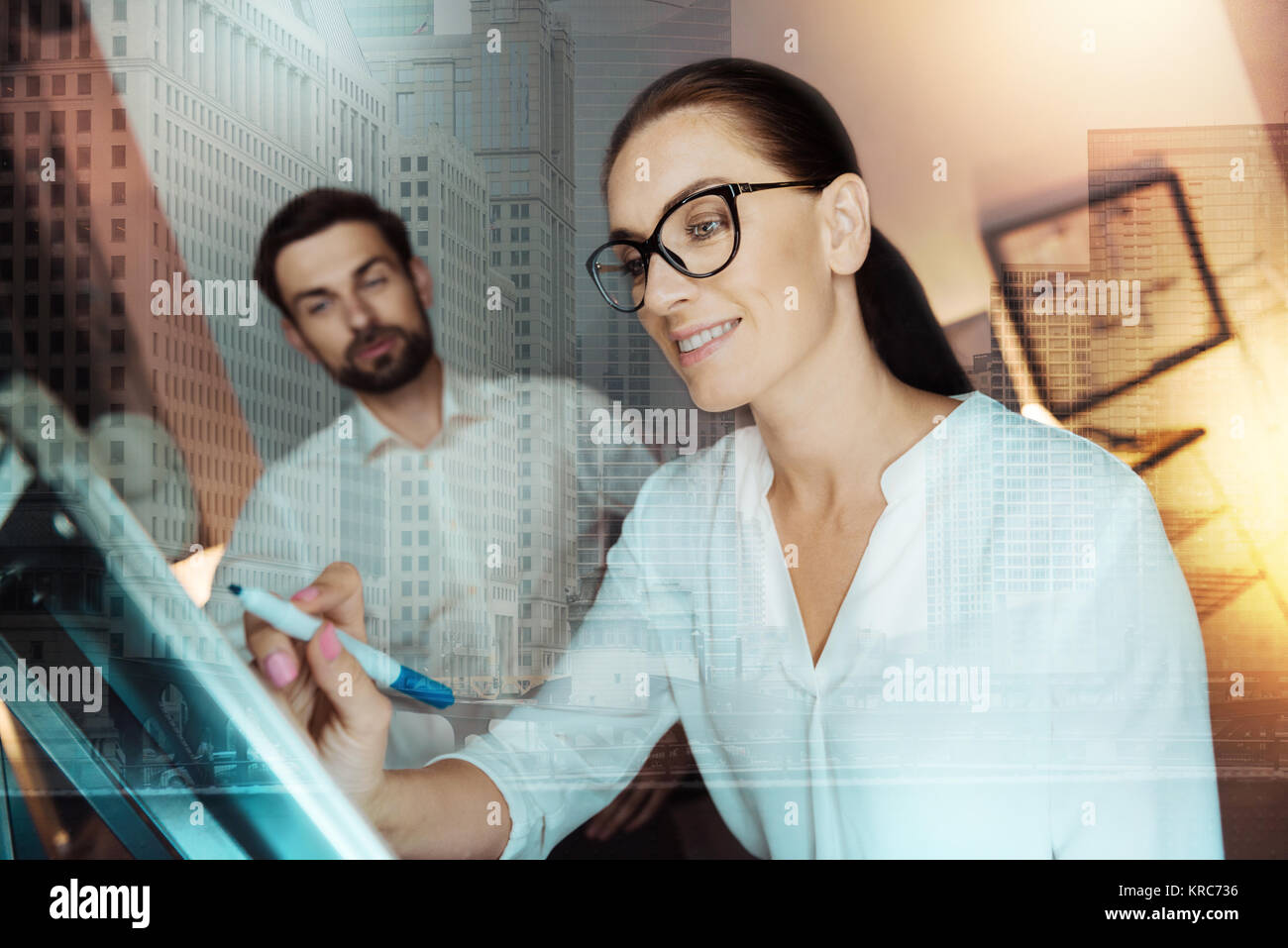 Beautiful young woman writing on whiteboard Stock Photo - Alamy