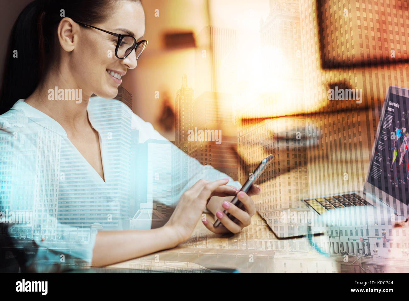 Beautiful woman texting her friends at work Stock Photo - Alamy