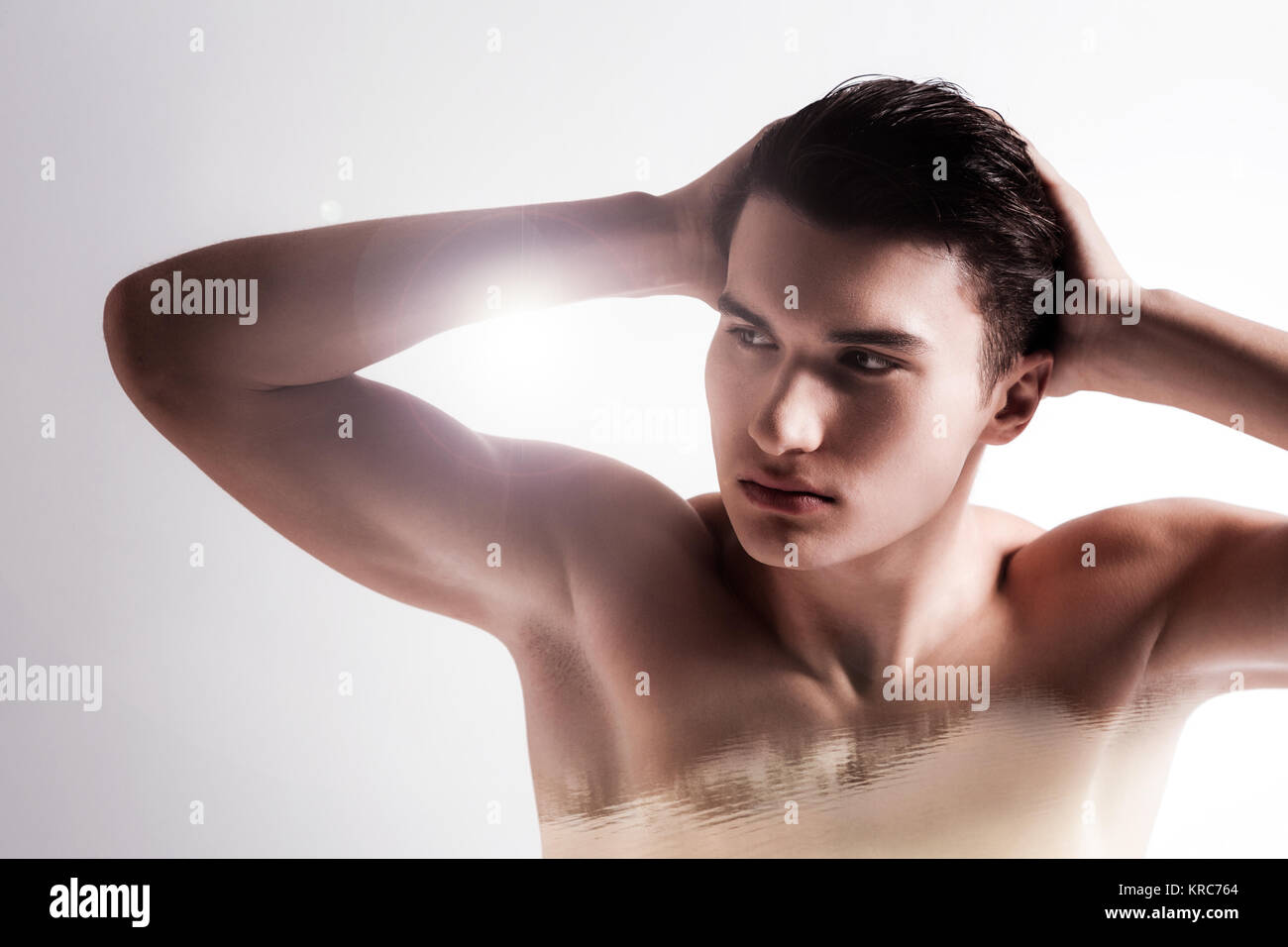 Serious young man looking aside Stock Photo - Alamy