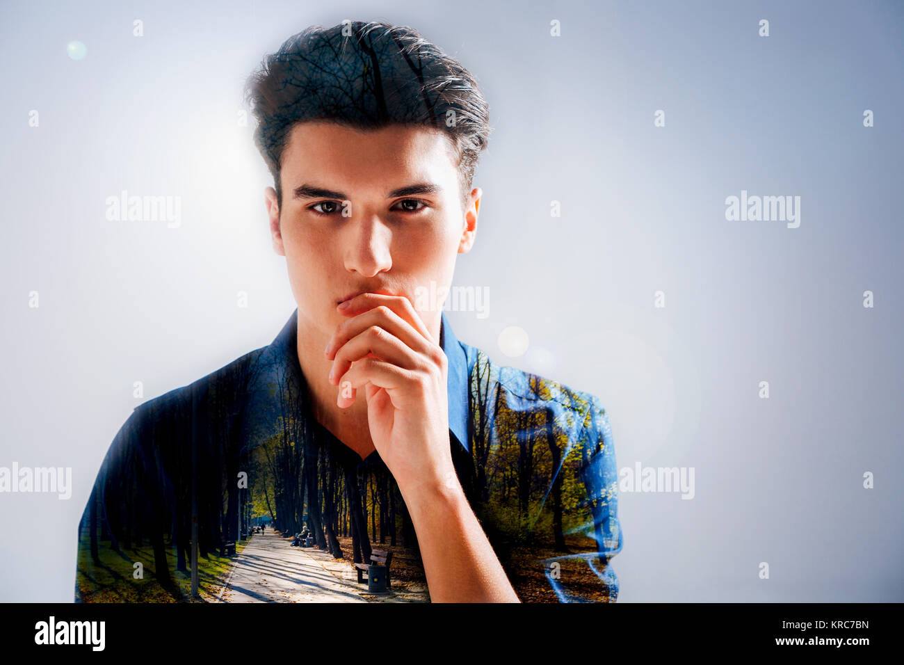 Thoughtful young man thinking about the park Stock Photo - Alamy