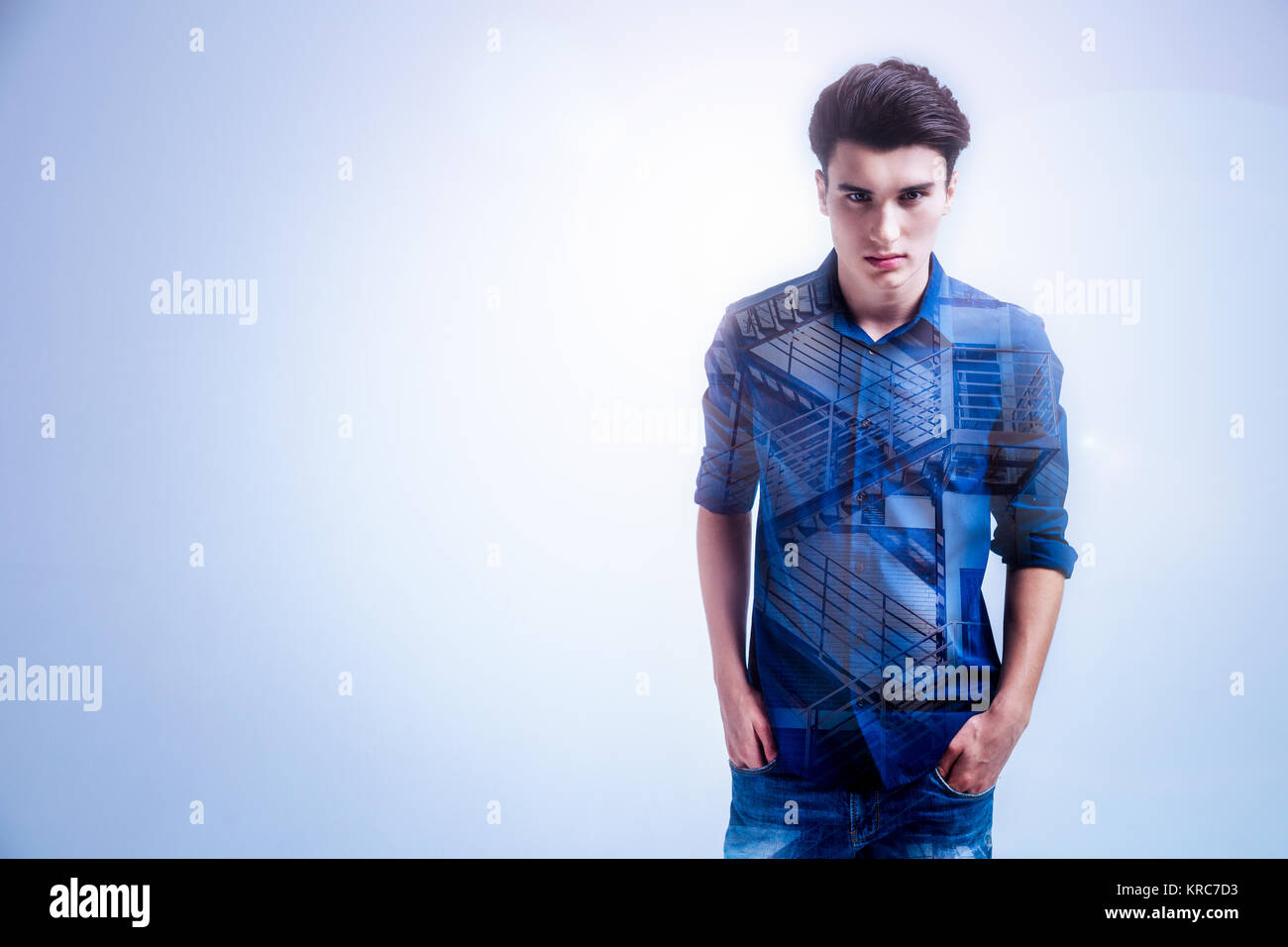 Nice young man putting his hands into pockets Stock Photo - Alamy