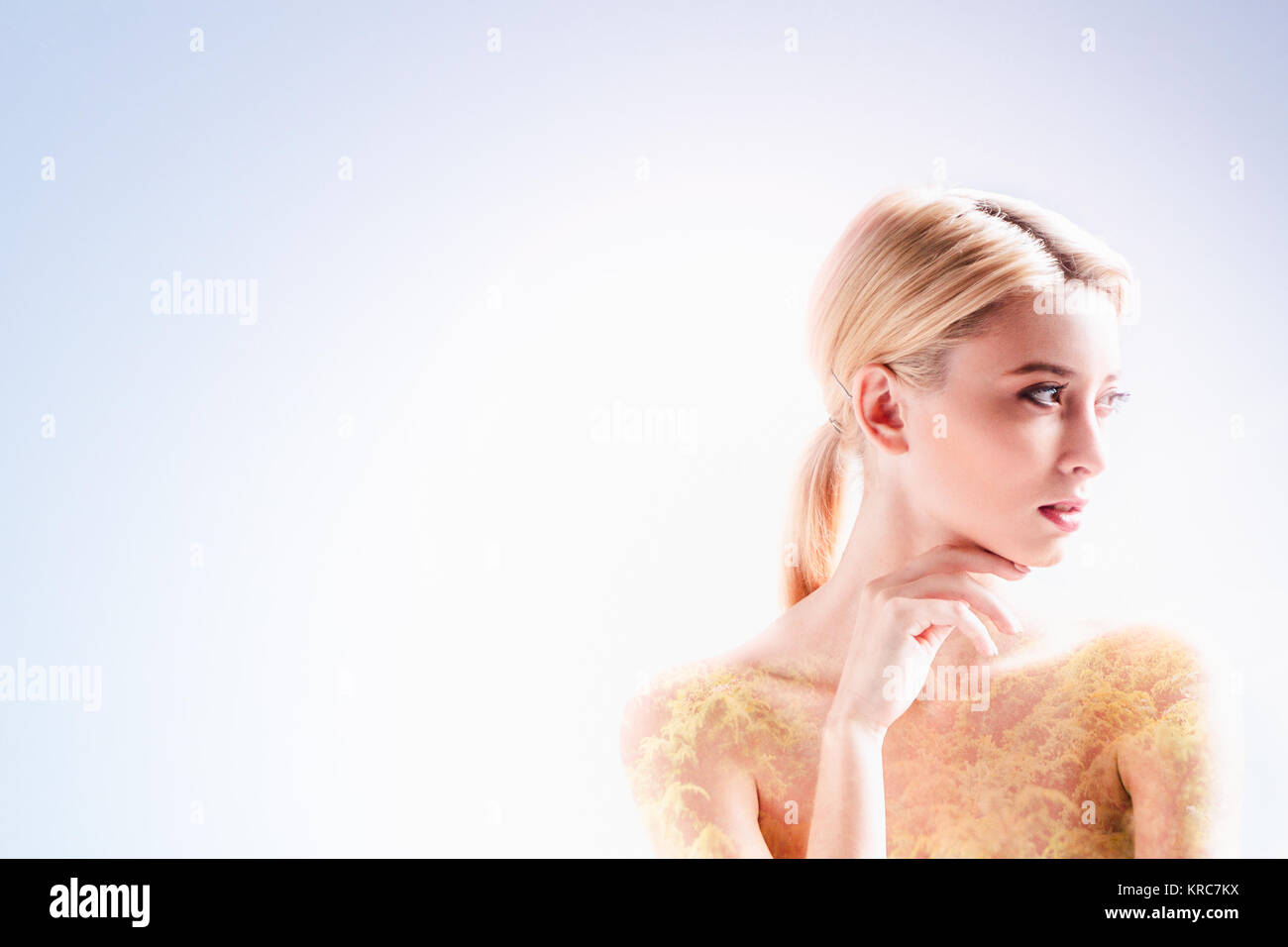 Attractive pretty woman holding her chin Stock Photo - Alamy