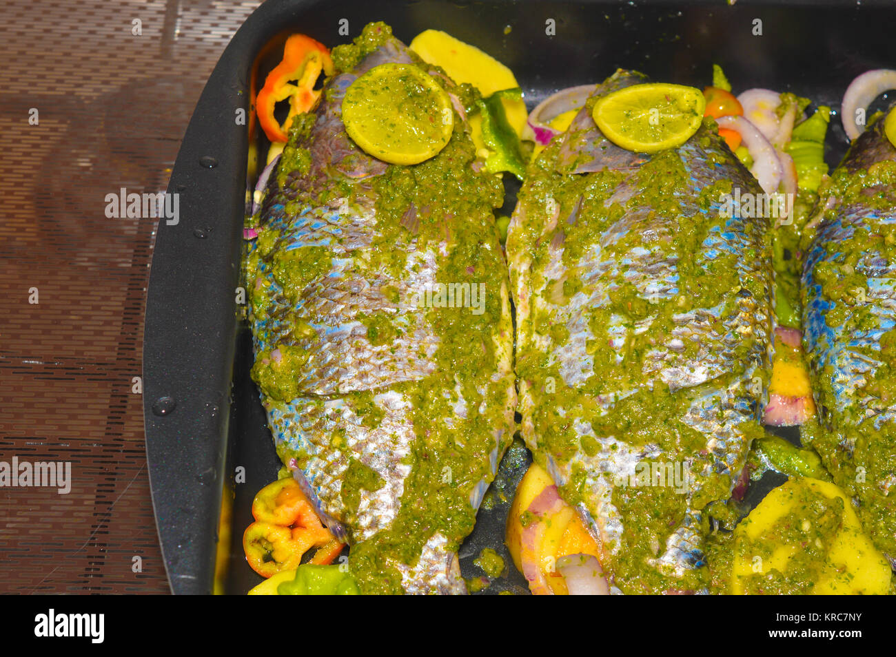 fresh uncooked spiced tilapia fish Stock Photo - Alamy