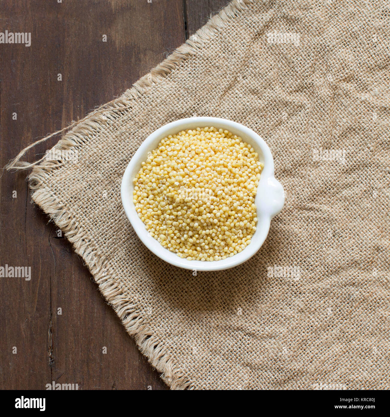 Raw millet in a bowl Stock Photo - Alamy