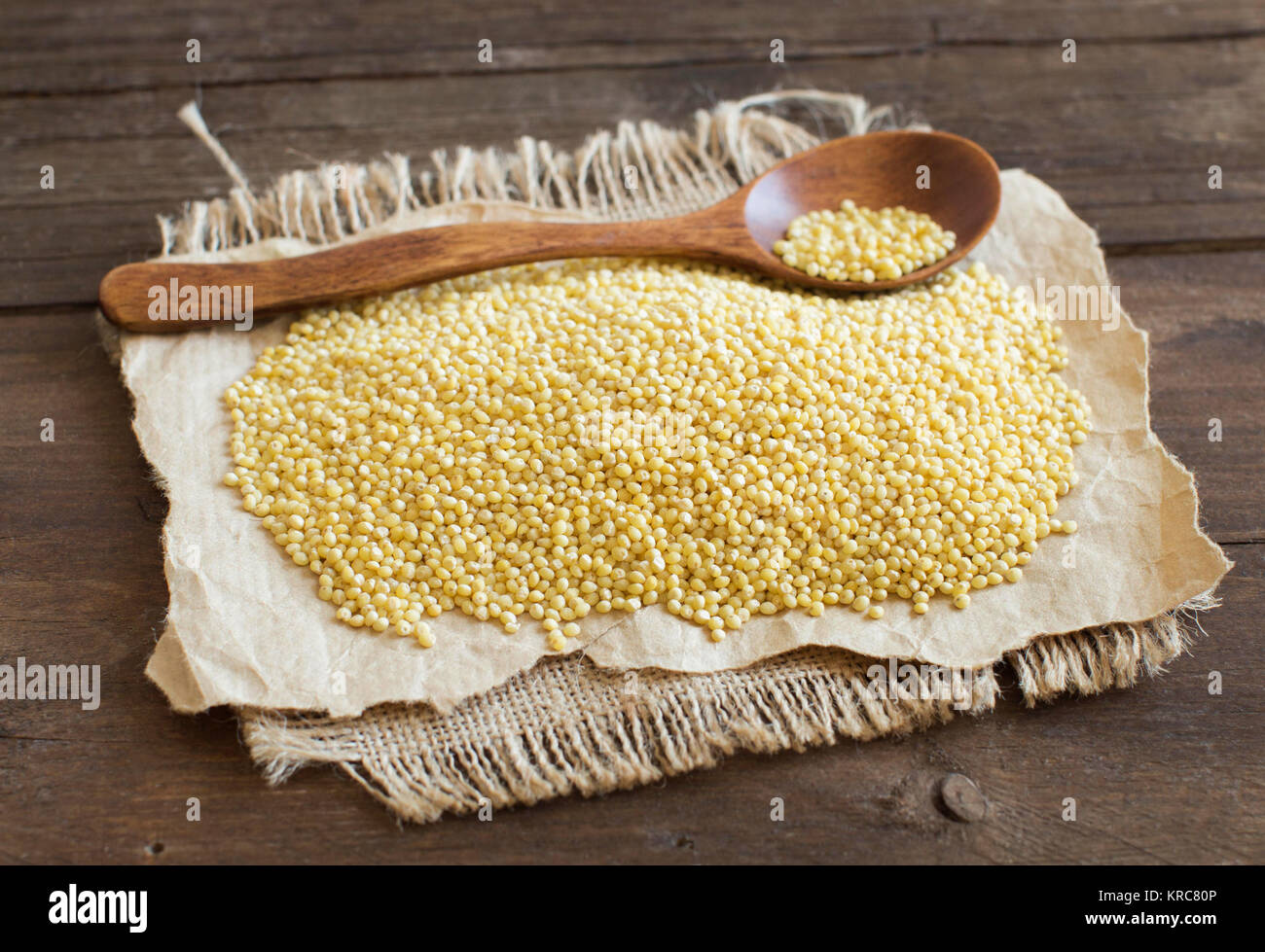 Raw millet with a spoon Stock Photo - Alamy