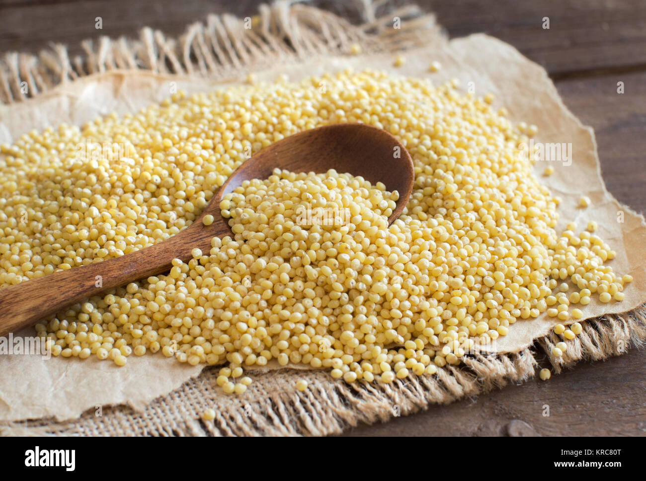 Raw millet with a spoon Stock Photo - Alamy