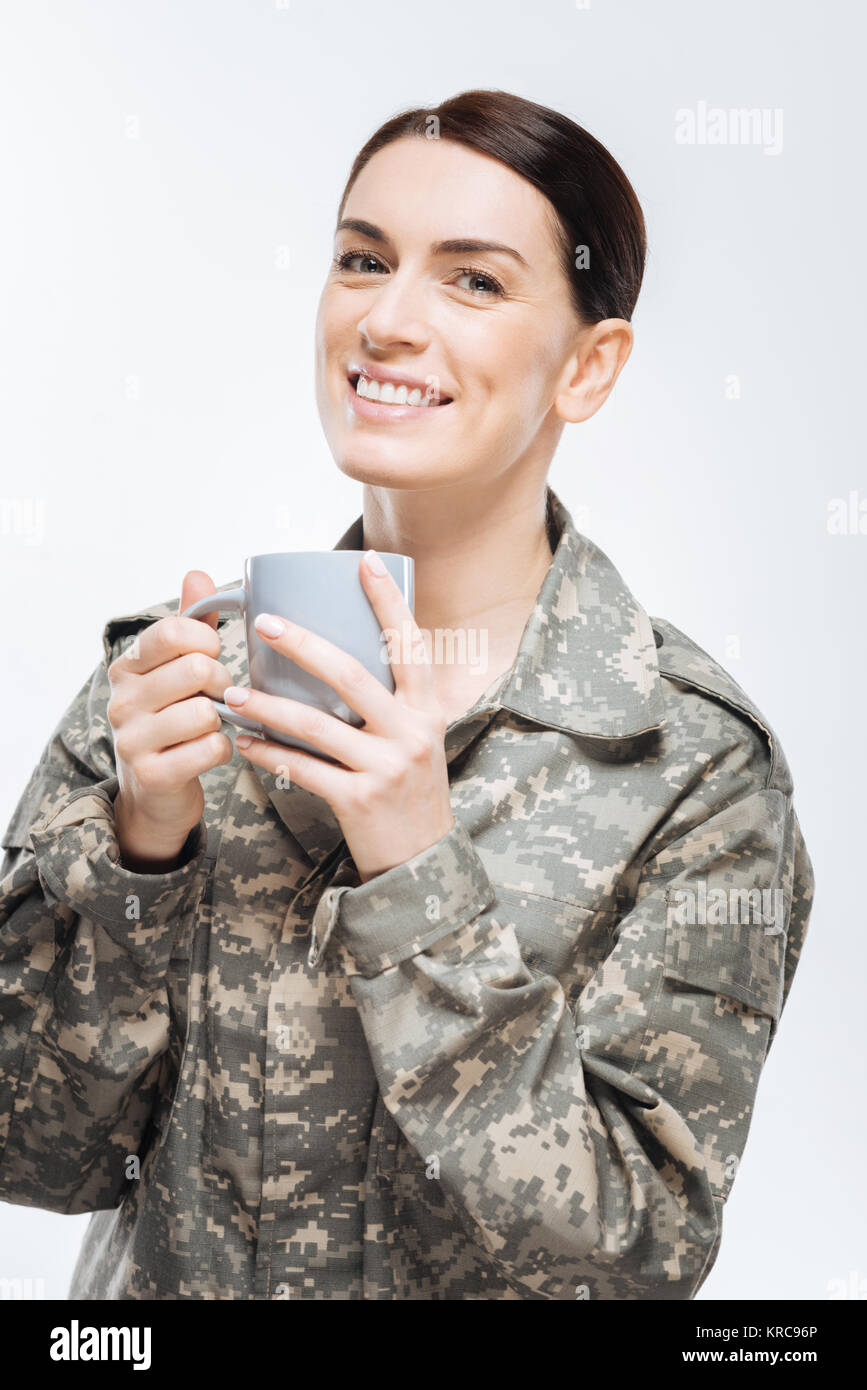 Joyful female soldier drinking tea Stock Photo - Alamy