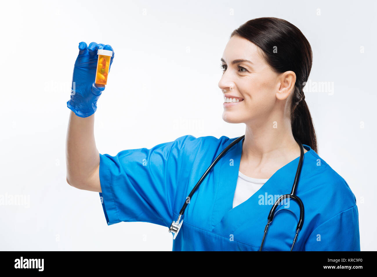 Appealing female laboritorian examining pills Stock Photo - Alamy