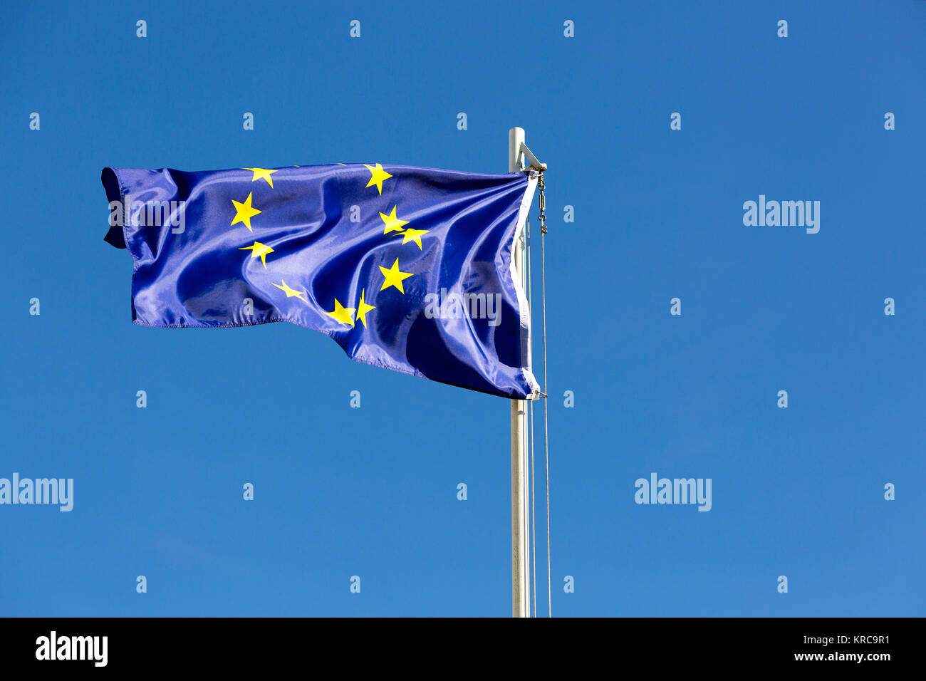 Flag of European Union on a flagpole in front of blue sky Stock Photo ...