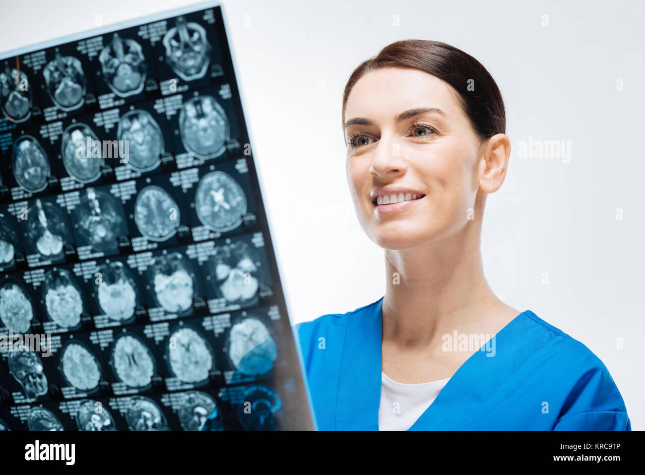 Thoughtful female doctor studying scan Stock Photo - Alamy
