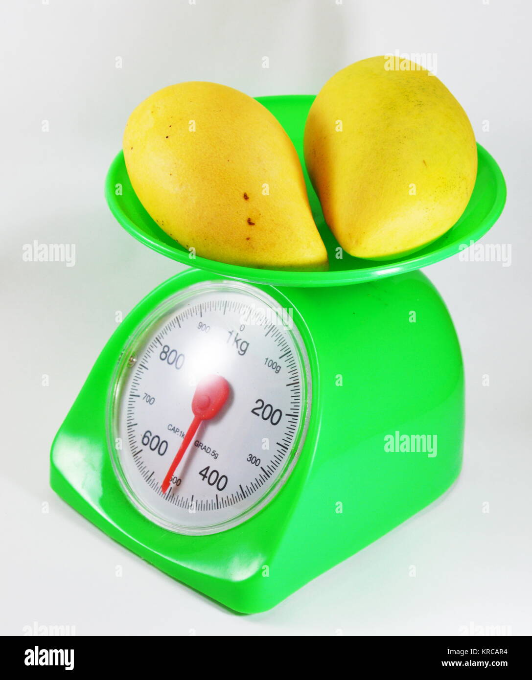 mango on green weighting scale tray Stock Photo - Alamy