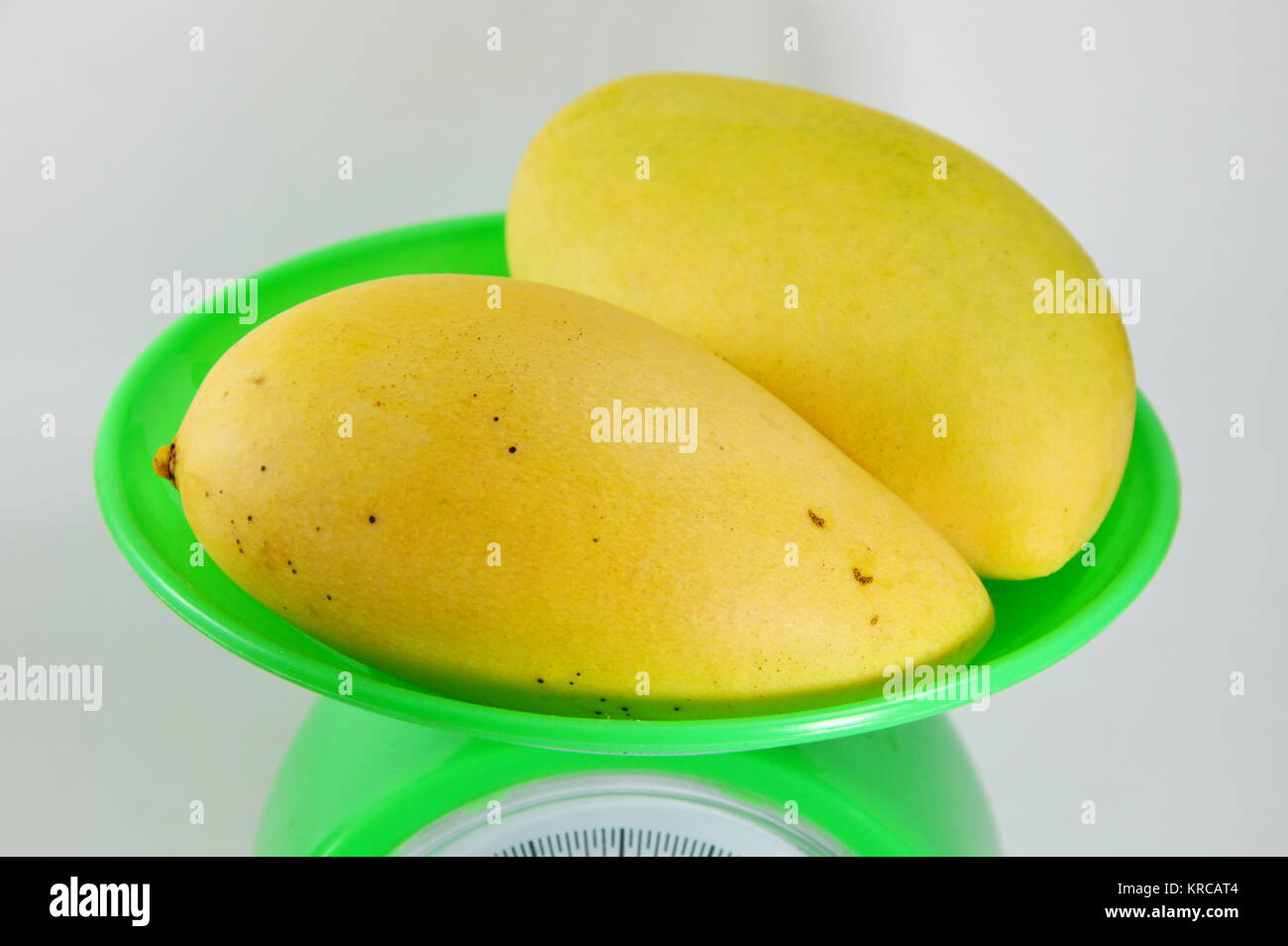 mango on green weighting scale tray Stock Photo - Alamy