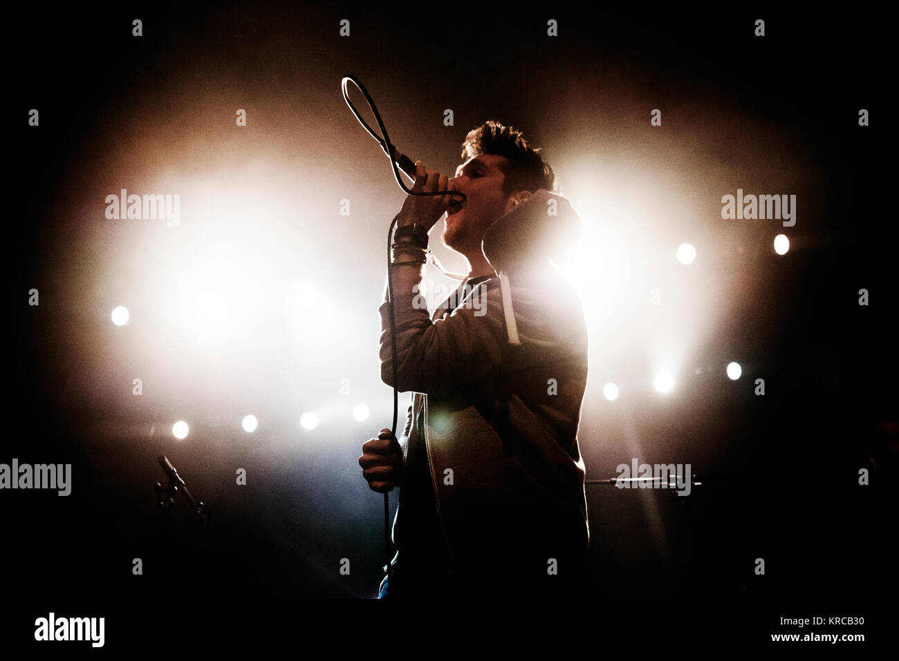 Bastille lead singer Dan Smith pictured in profile with the microphone ...