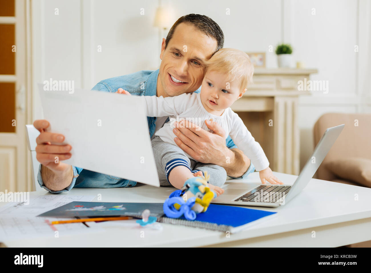 Emotional working father showing his graphics to a little baby Stock ...
