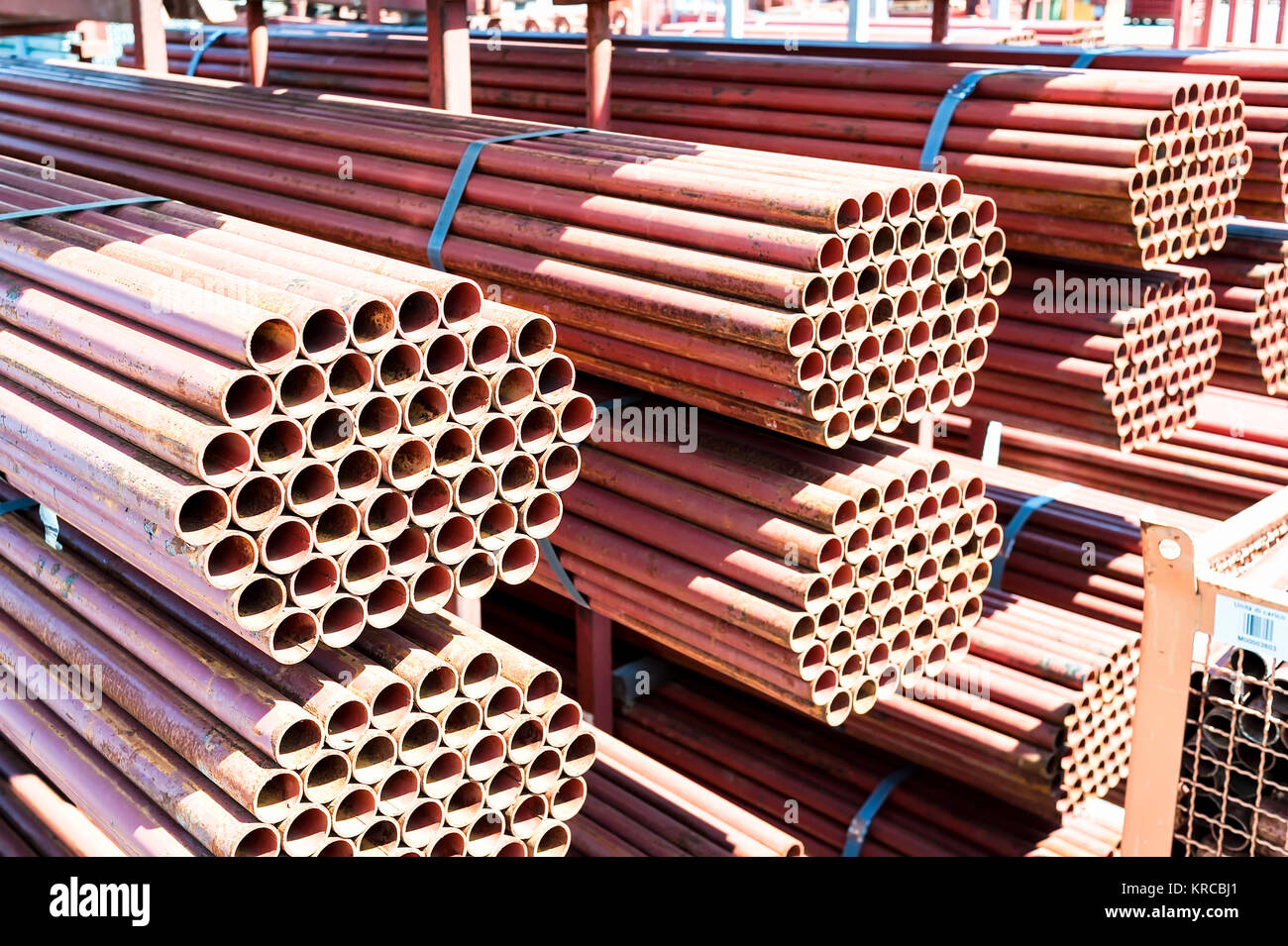 Steel Pipes bunch on the rack in warehouse Stock Photo - Alamy