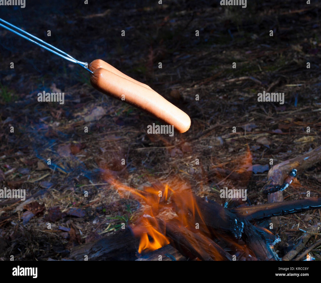 Pair of hot dogs being cooked over an open fire Stock Photo - Alamy