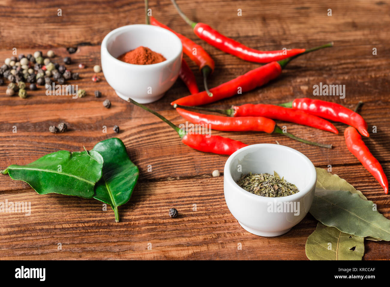 Different condiment in white bowls or scattered on kitchen table Stock ...