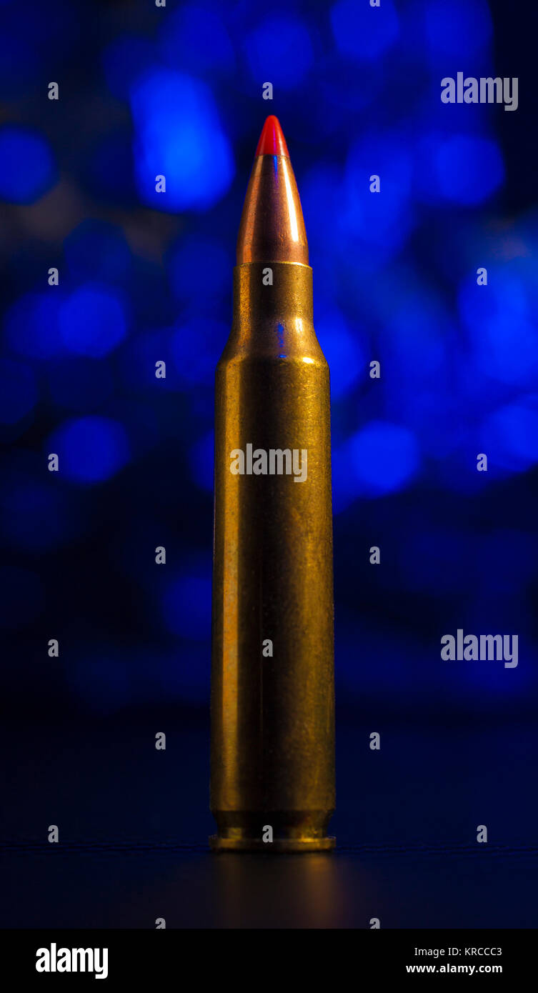 Cartridge and bullet used in an AR-15 with a blue background Stock ...