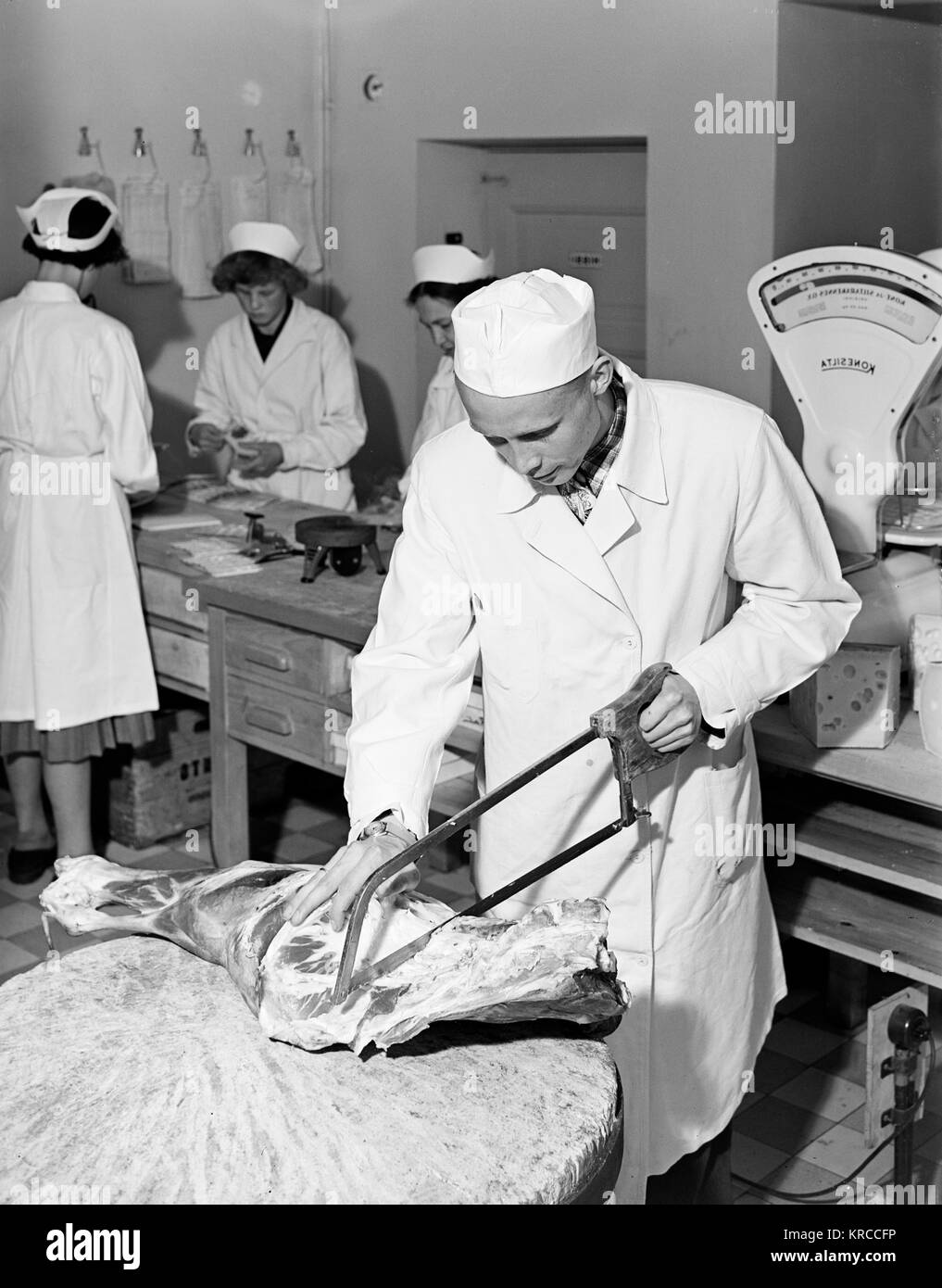 Butcher sawing sheep meat in butchery, Finland, 1950s Stock Photo - Alamy